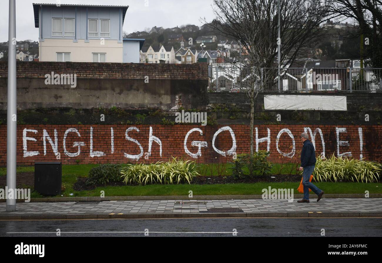 Anti English graffiti is written in white paint on a brick wall in the ...