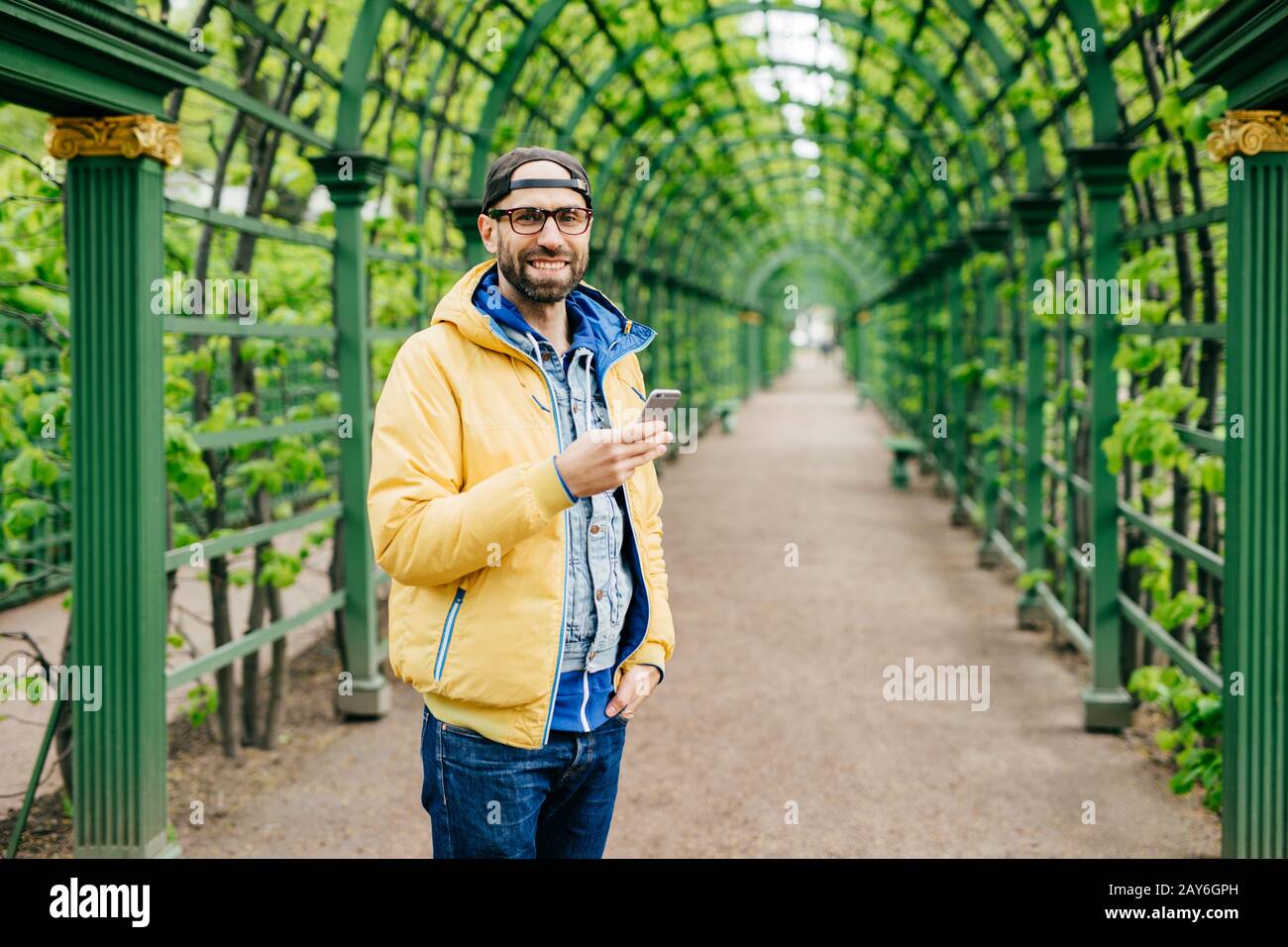 Young student male with beard having stylish clothes standing against ...