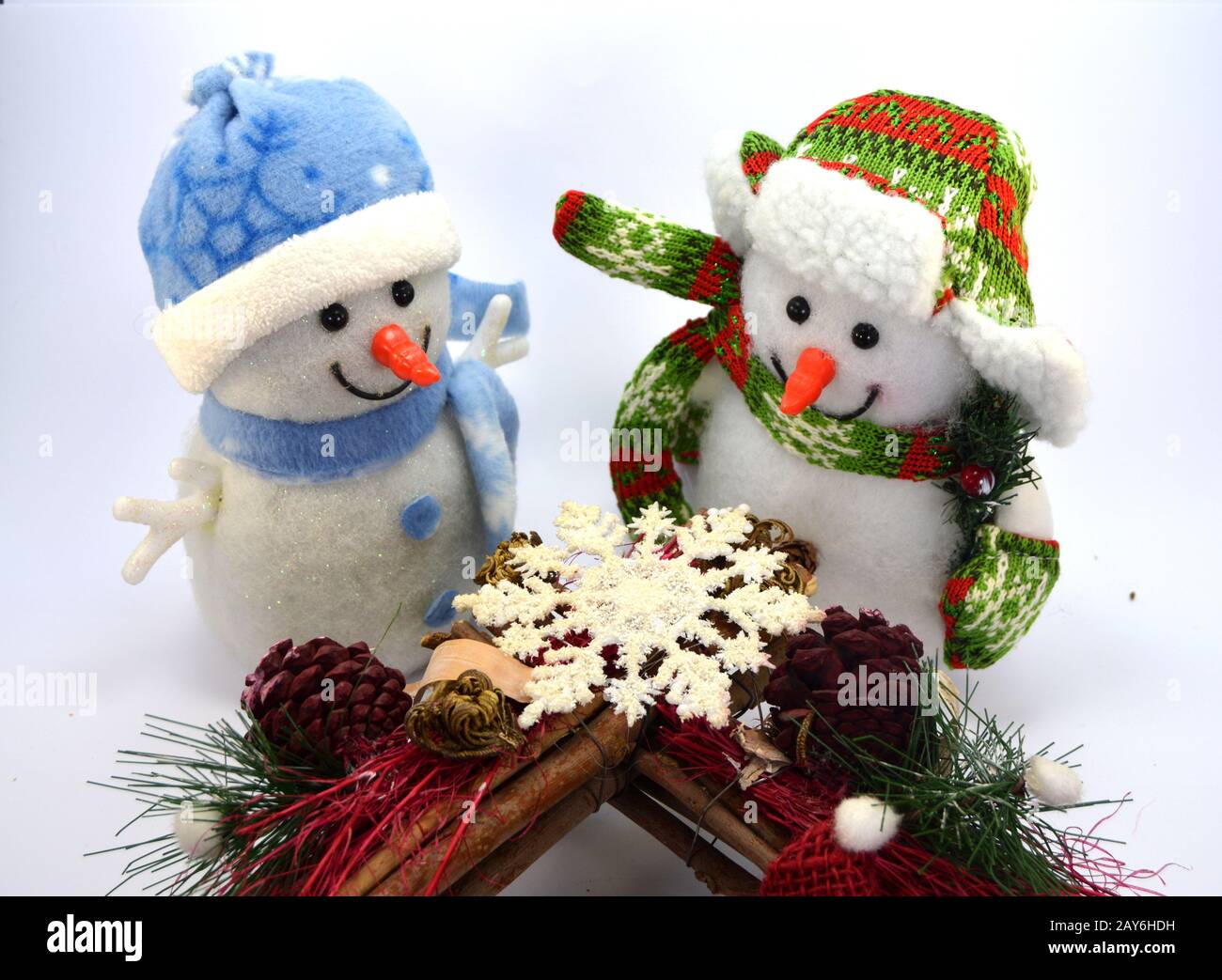 Snowman duo with a snow star and two tassels on white background Stock ...