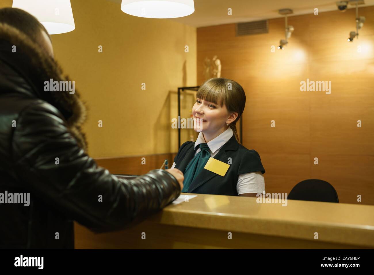 Hotel manager welcoming smiles the guest Stock Photo - Alamy