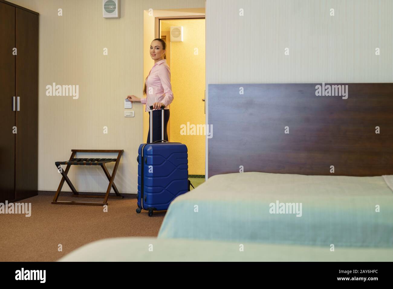Pretty female guest at threshold of hotel room Stock Photo - Alamy