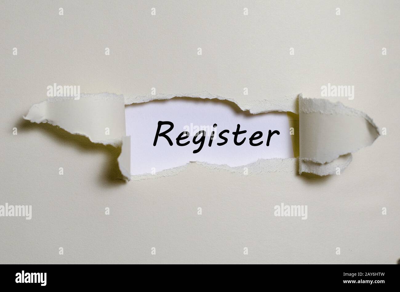 The word register appearing behind torn paper Stock Photo - Alamy