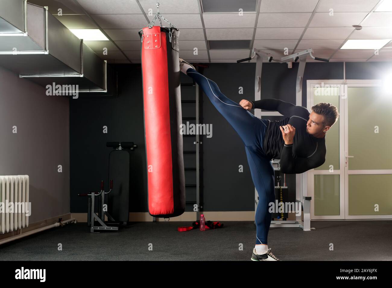 At gym. Photo of boxer training his kick Stock Photo - Alamy
