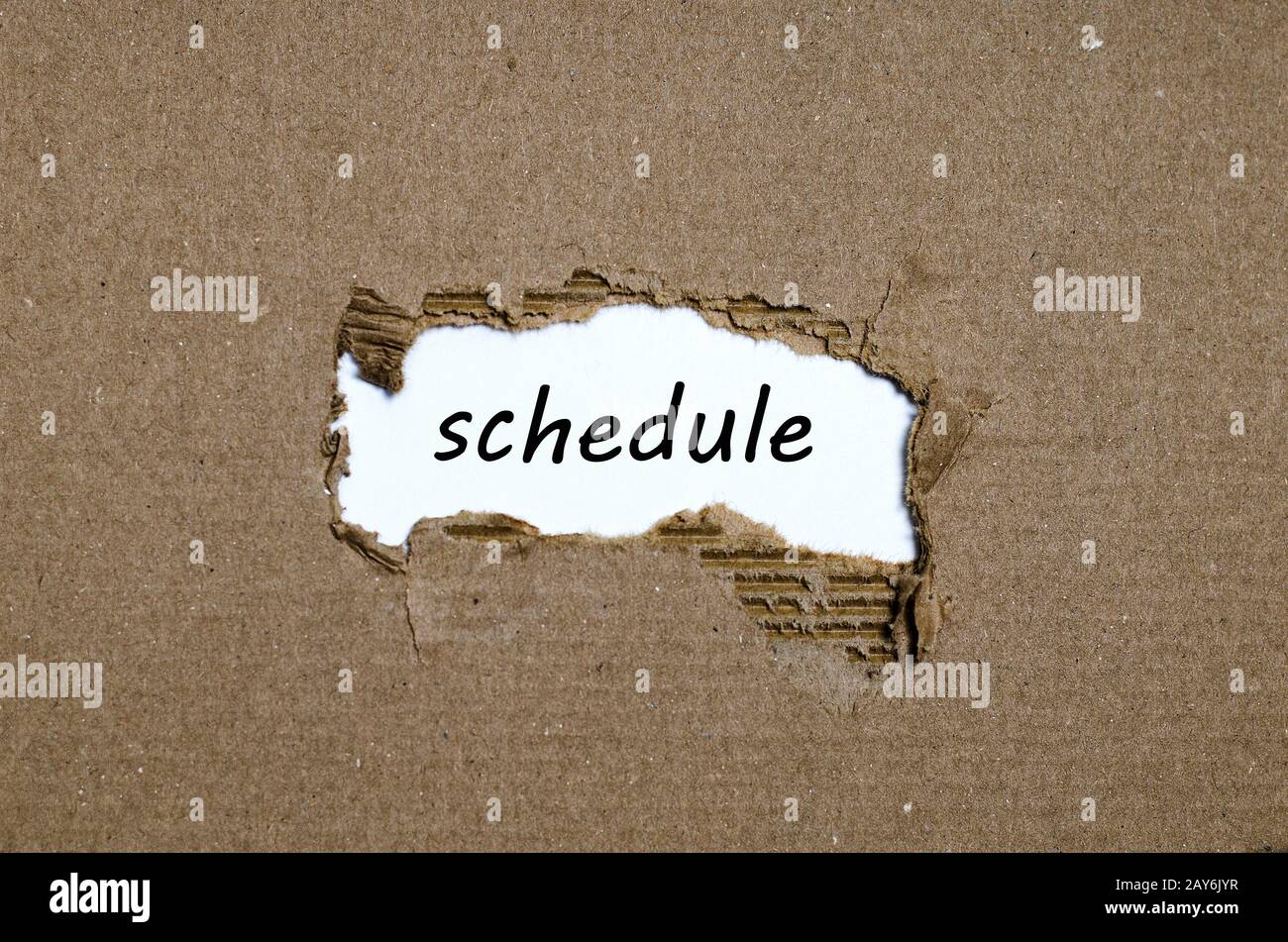 The word schedule appearing behind torn paper Stock Photo - Alamy