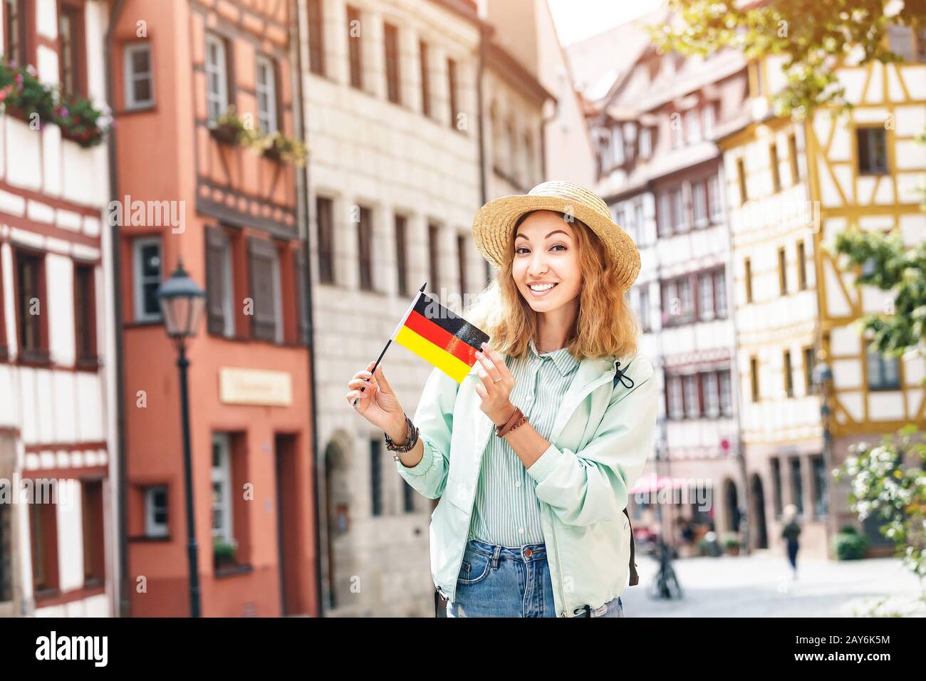 Young asian woman tourist traveling with german flag near the famous ...