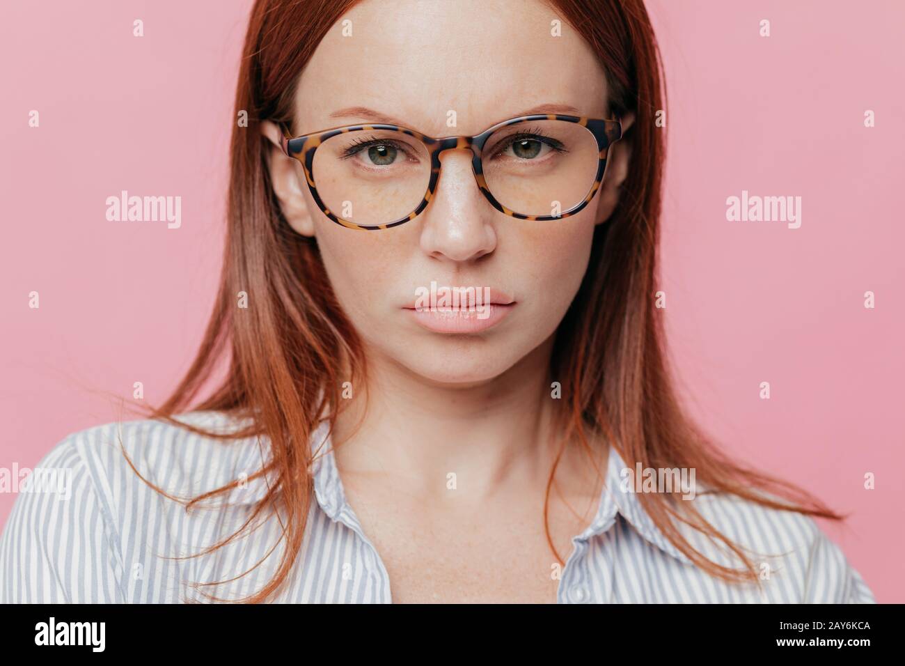 Close up shot of lovely female model wears big optical glasses, has ...