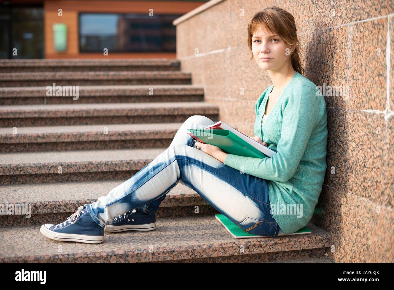 Girl sitting on stairs hi-res stock photography and images - Alamy