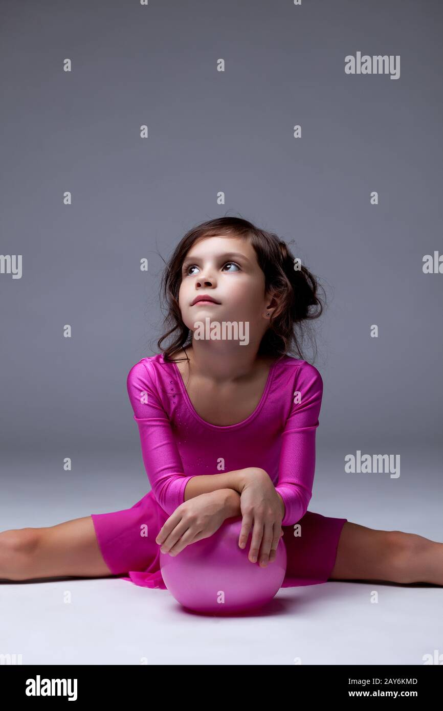 Thoughtful young girl posing with gymnastic ball Stock Photo - Alamy