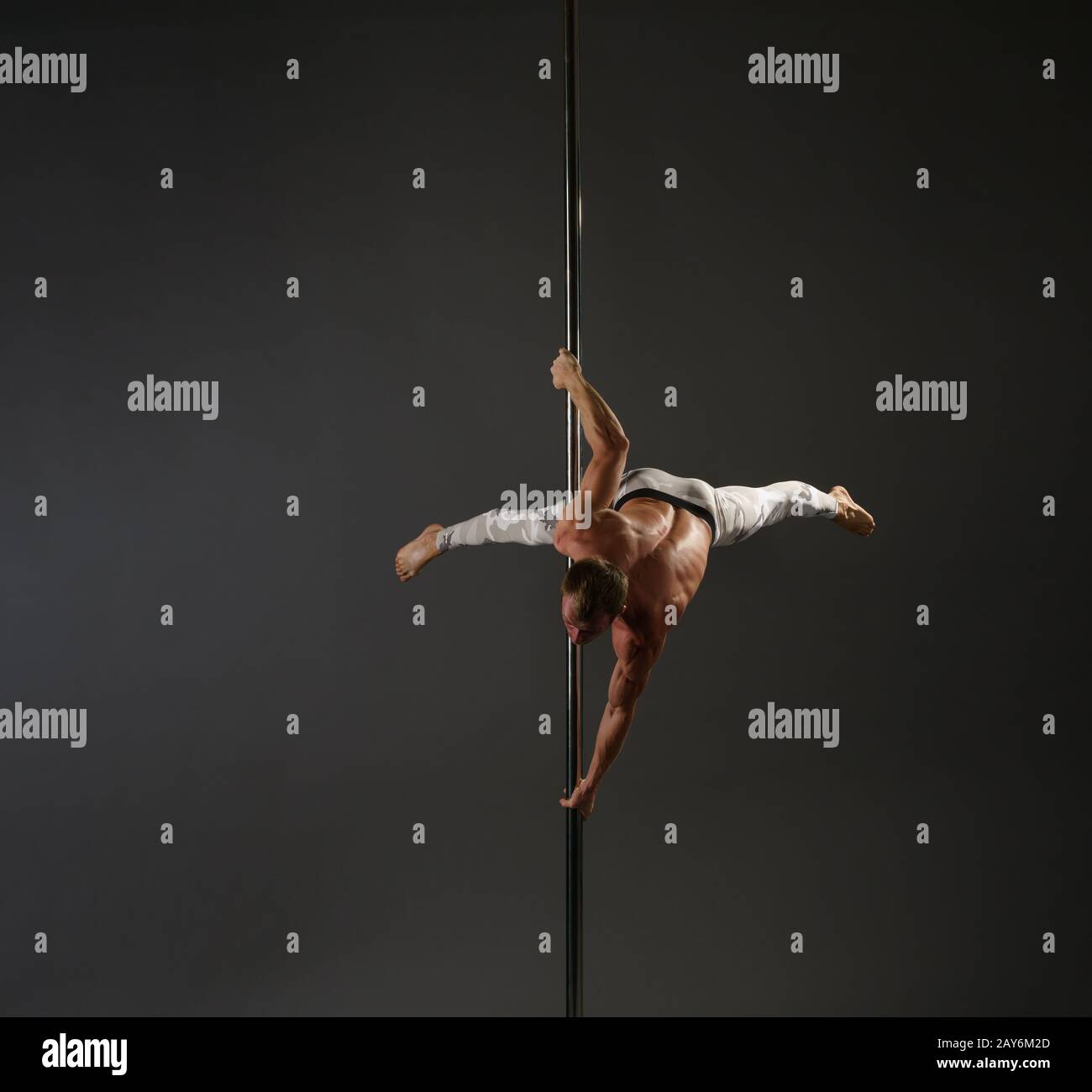 Pole dancer making exercises studio shot Stock Photo - Alamy