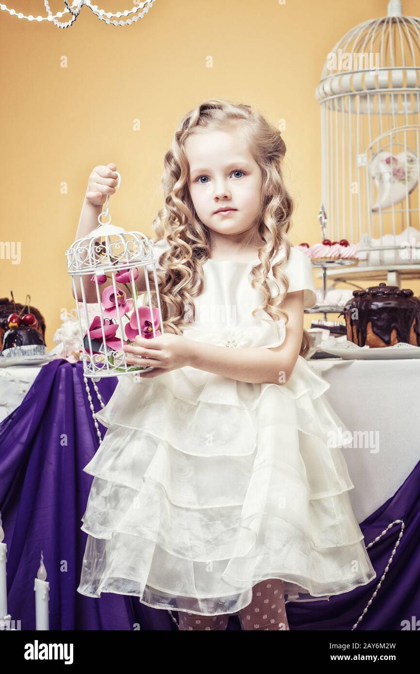 Smart little girl posing in cozy decorated studio Stock Photo - Alamy