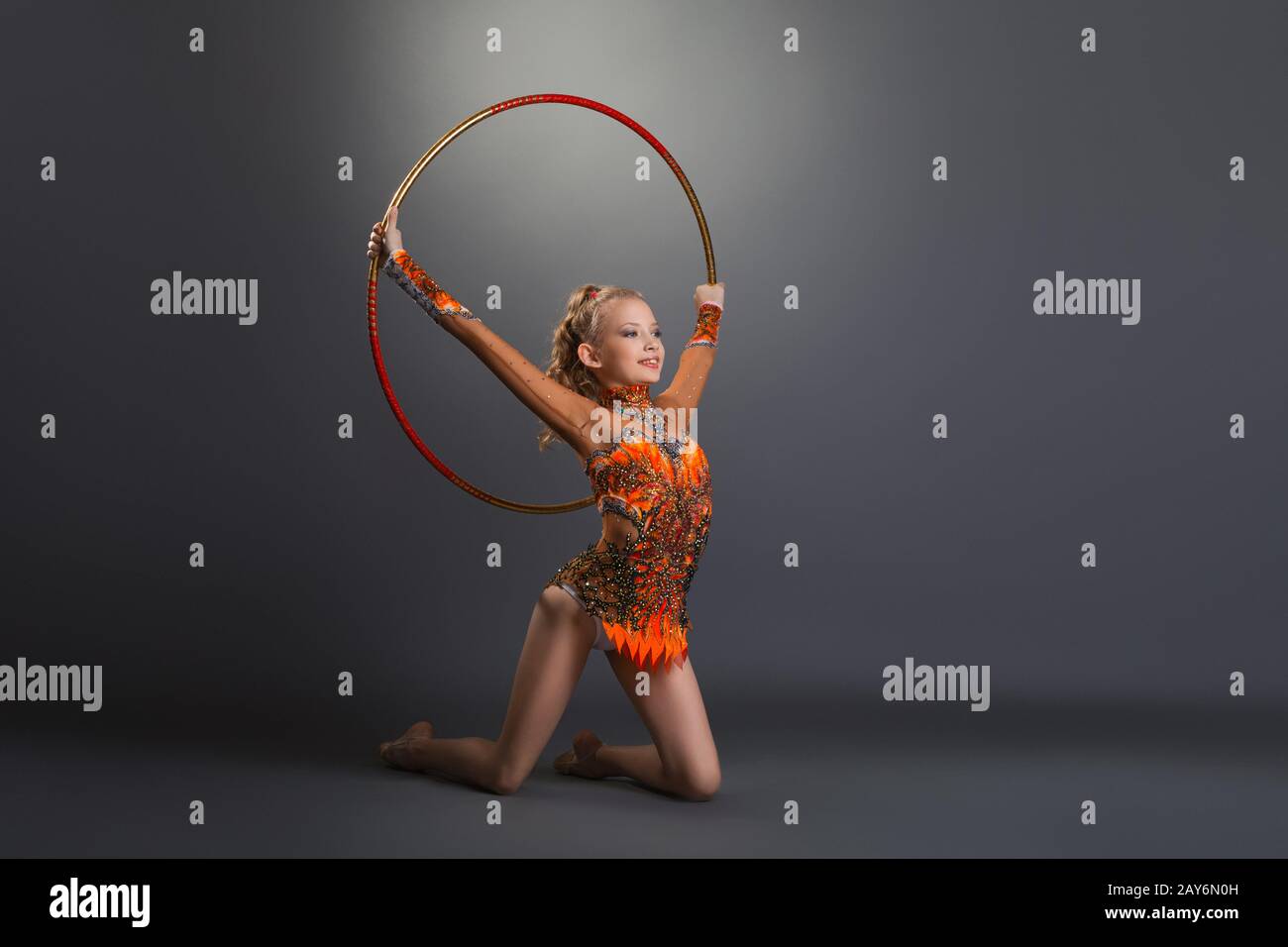 Gymnast girl performing with hoop at studio Stock Photo - Alamy