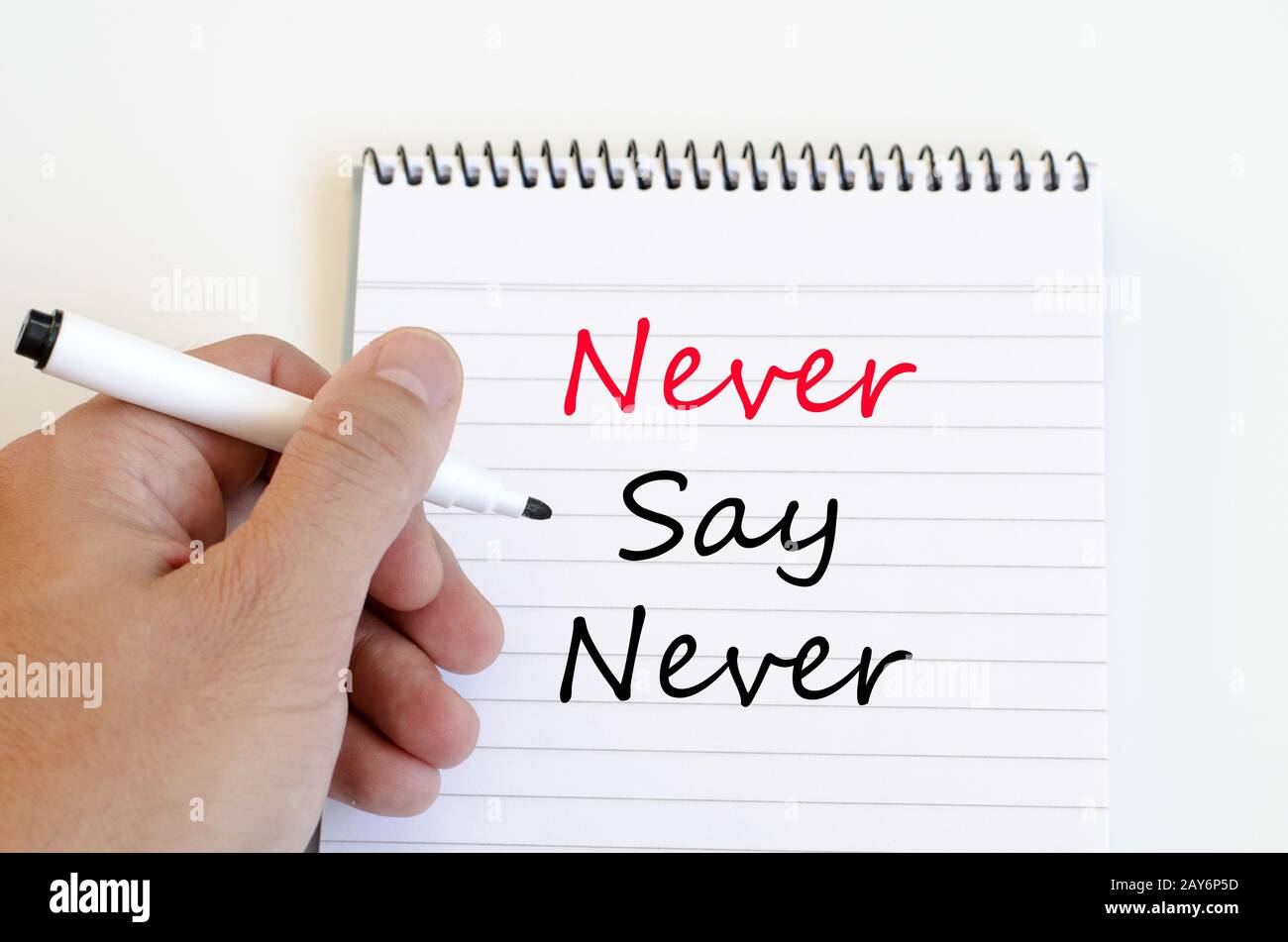 Human hand over wooden background and never say never text concept ...