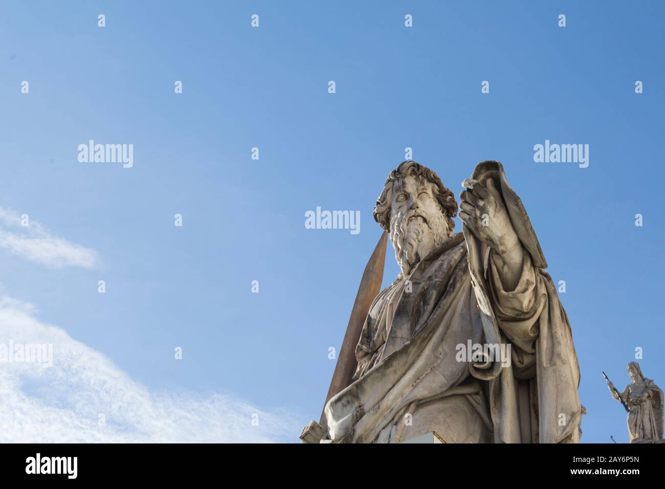 Statue of Saint Pedro with the keys behind a clear sky with few clouds ...