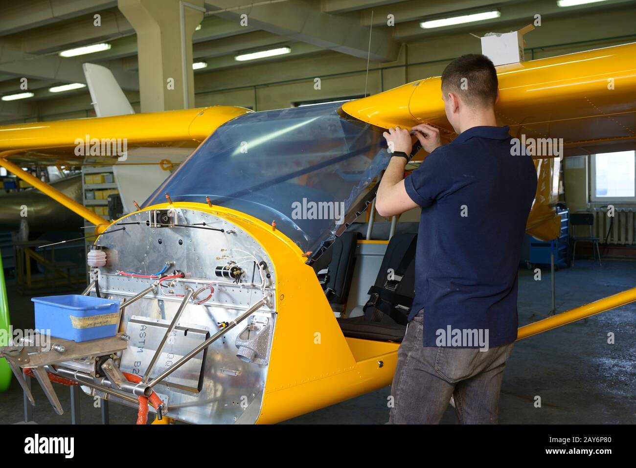 Fitter fixing windscreen on the cockpit of the sport aircraft ...