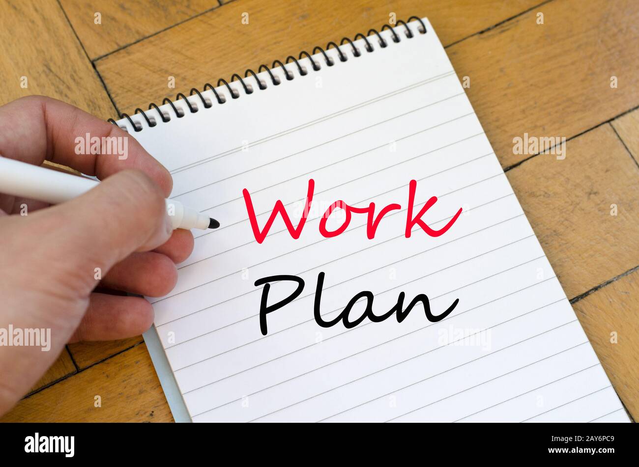 Human hand over wooden background and work plan text concept Stock ...