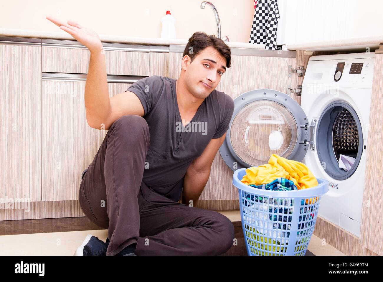 Young husband man doing laundry at home Stock Photo - Alamy