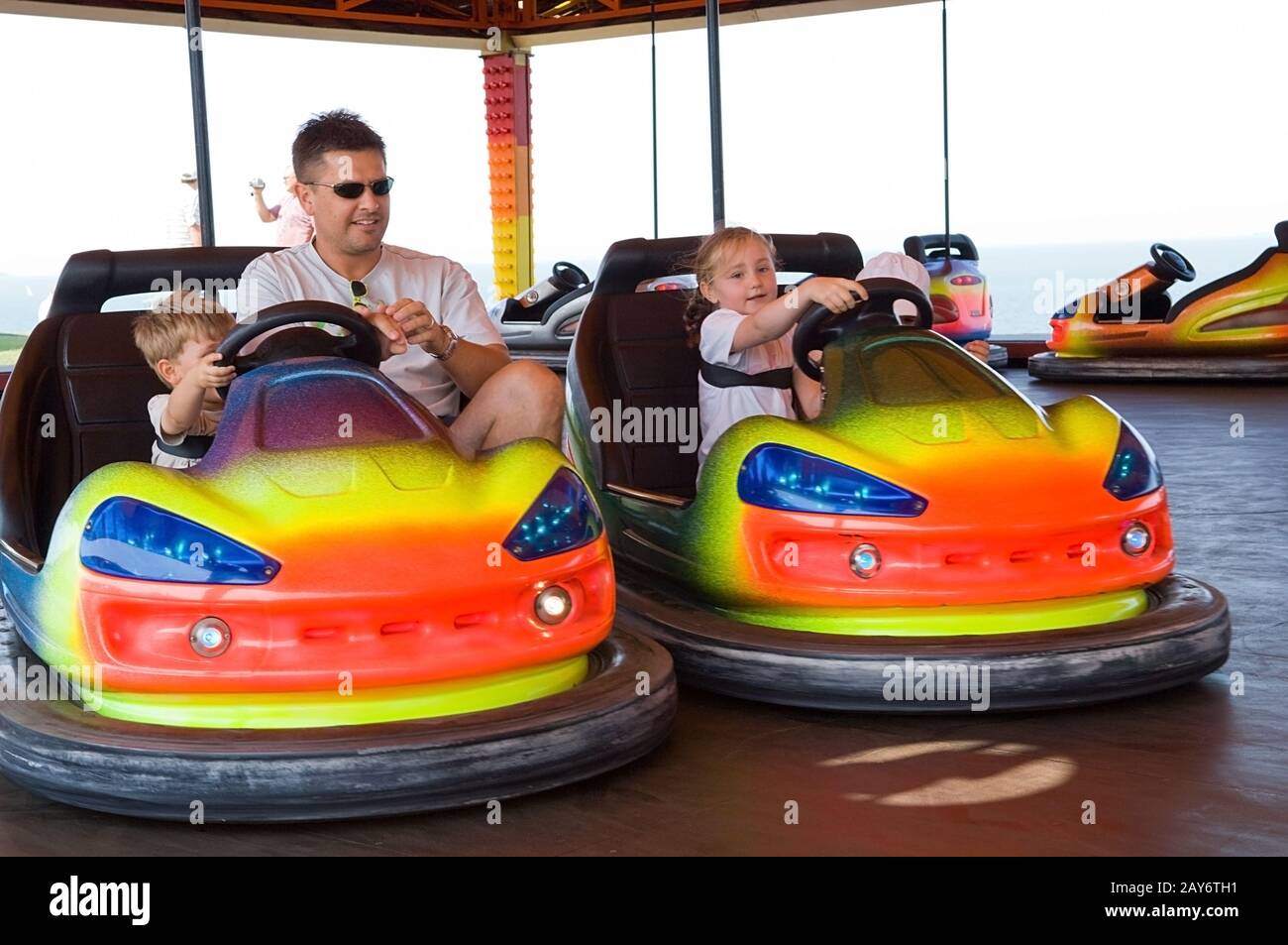 People on the dodgems at a fair showing the people having fun and ...