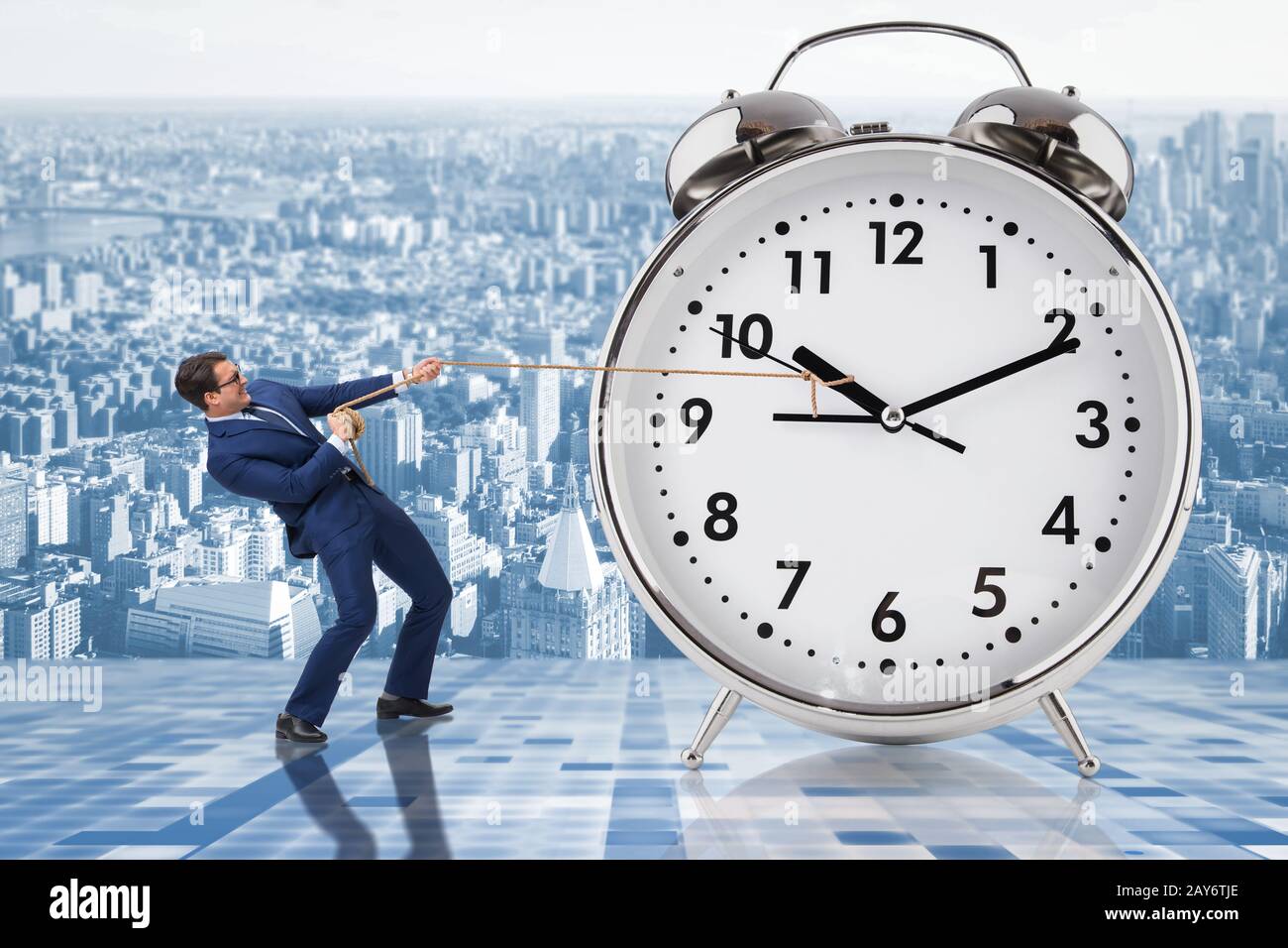 Businessman pulling clock in time management concept Stock Photo - Alamy