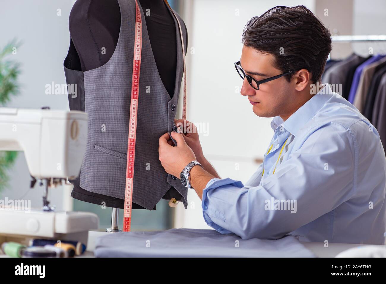 Young man tailor working on new clothing Stock Photo - Alamy