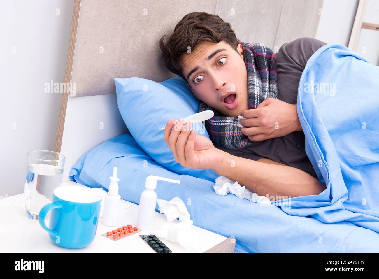 Sick man with flu lying in the bed Stock Photo - Alamy