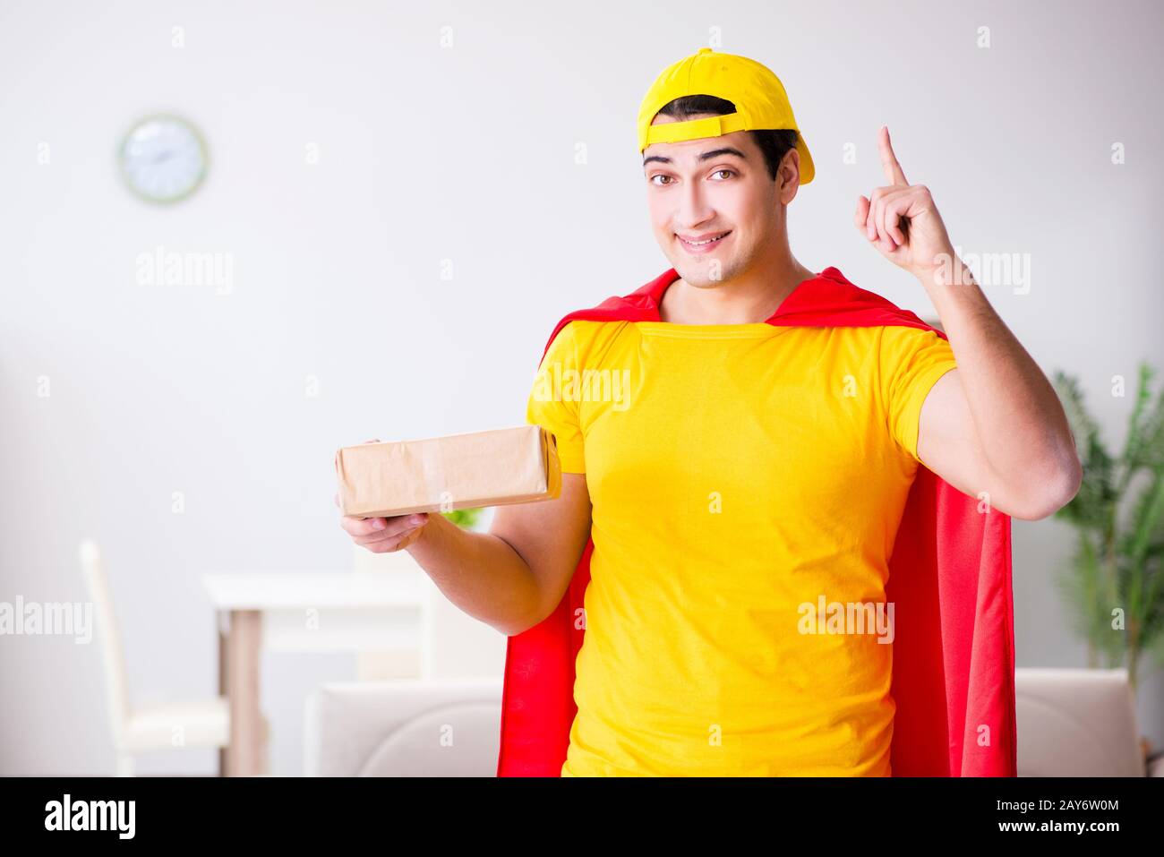 Superhero delivery guy with box Stock Photo - Alamy