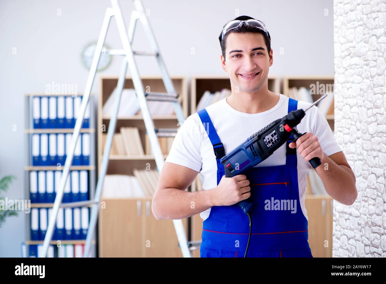 Repairman working with drilling drill perforator Stock Photo - Alamy