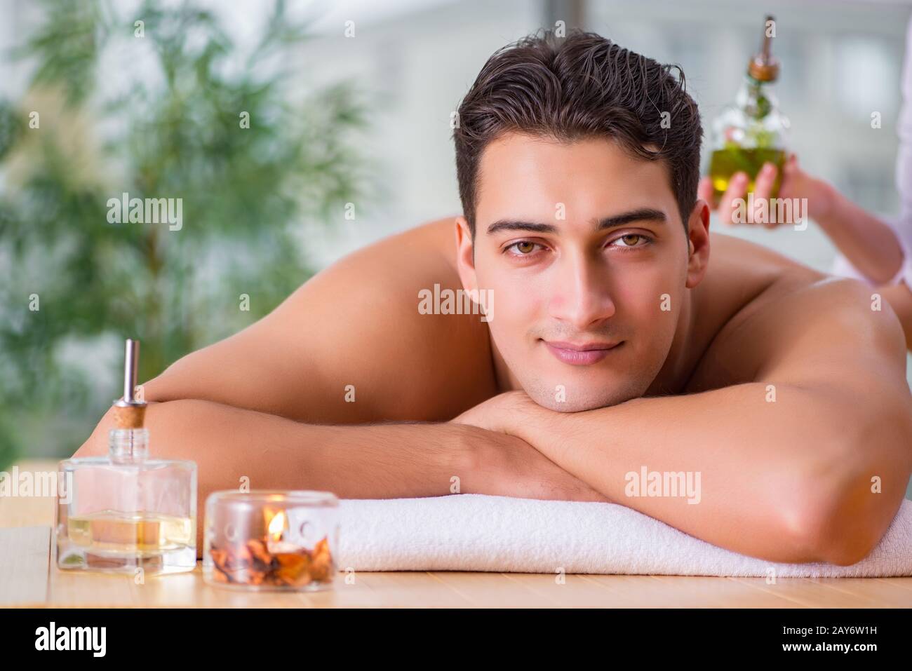 Handsome man during spa massaging session Stock Photo - Alamy