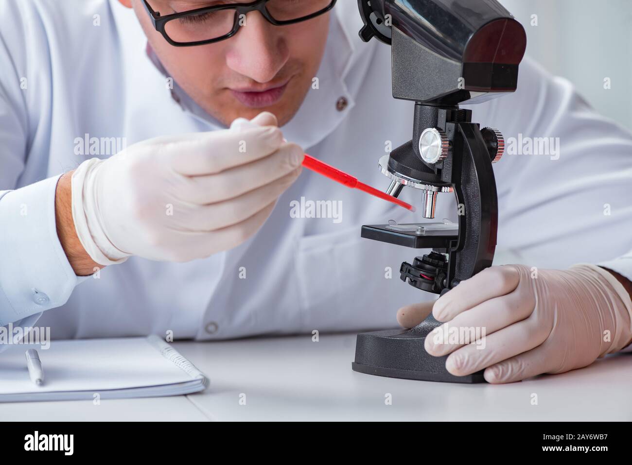 Young doctor doing the blood test Stock Photo - Alamy