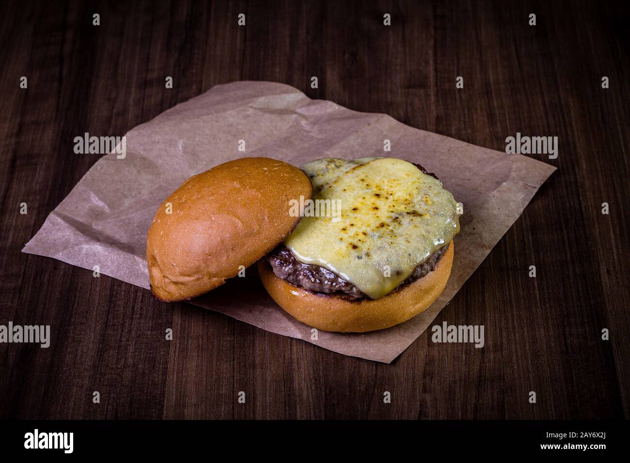 Craft beef burger with cheese on wood table and rustic background Stock ...