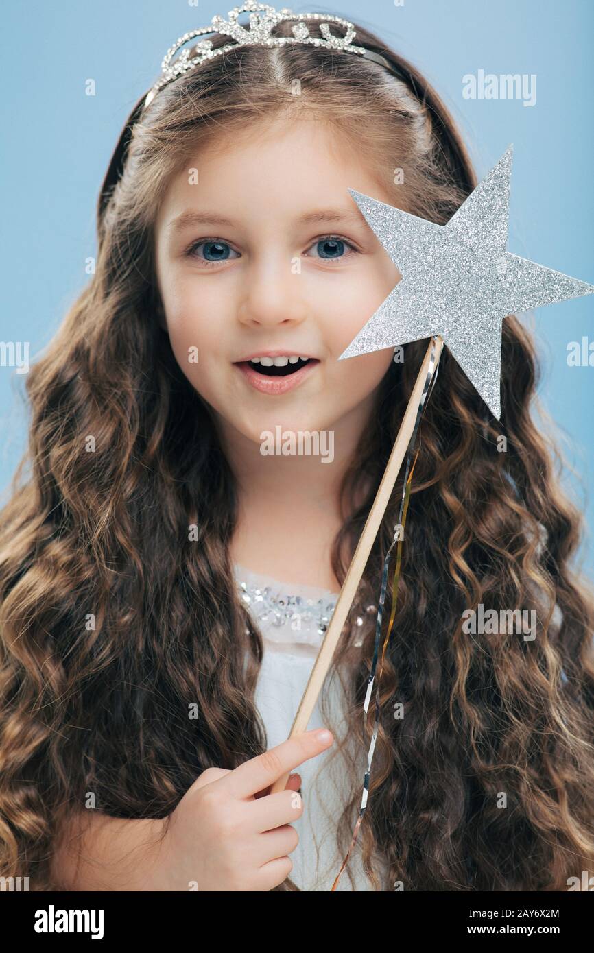 Close up shot of adorable blue eyed small European female princess has ...