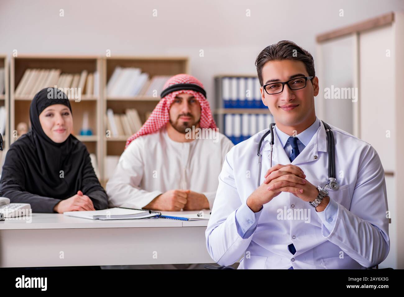 Doctor consulting arab family at hospital Stock Photo - Alamy