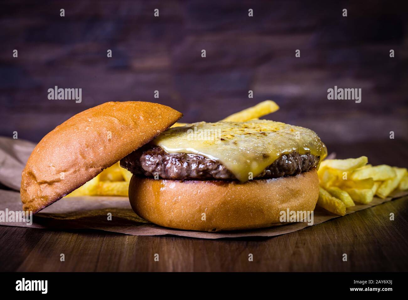 Craft beef burger with cheese on wood table and rustic background Stock ...