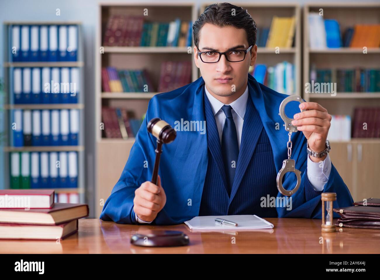 Handsome judge with gavel sitting in courtroom Stock Photo - Alamy