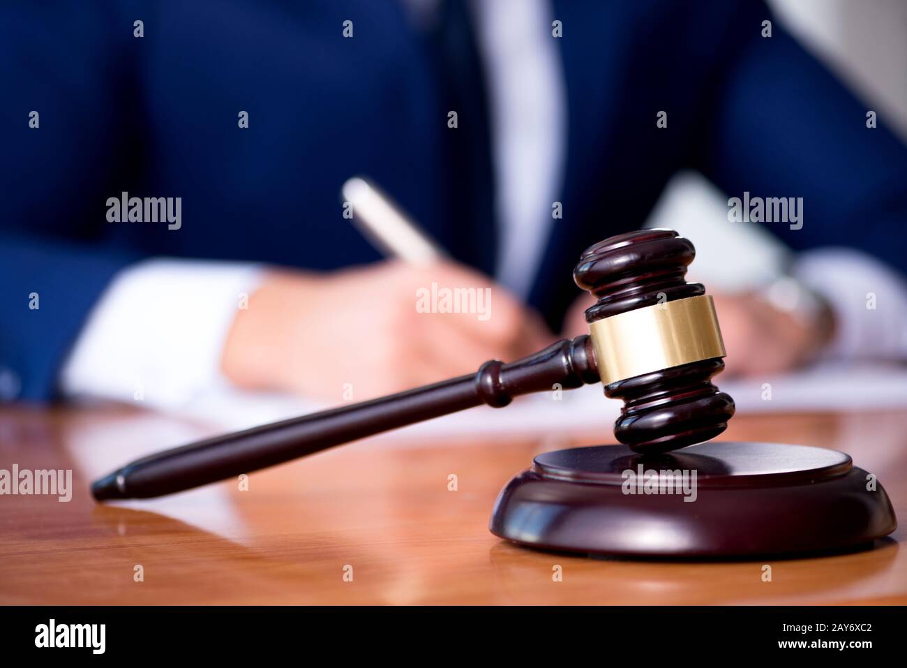 Handsome judge with gavel sitting in courtroom Stock Photo - Alamy