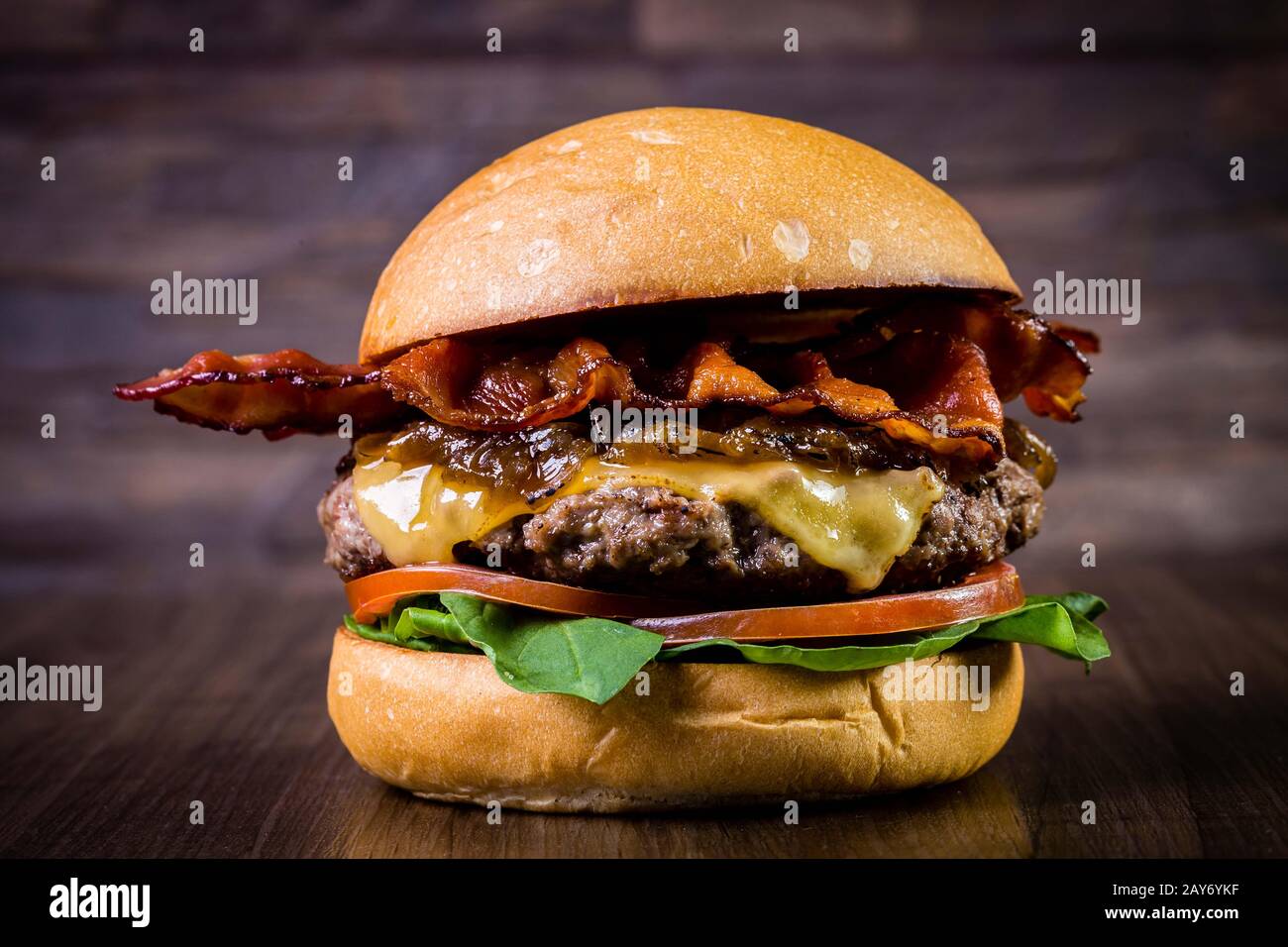 Craft beef burger with cheese, bacon, caramelized onion and rocket ...