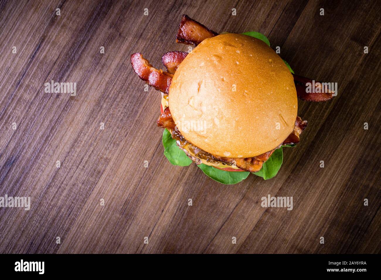 Craft beef burger with cheese, bacon, caramelized onion and rocket ...