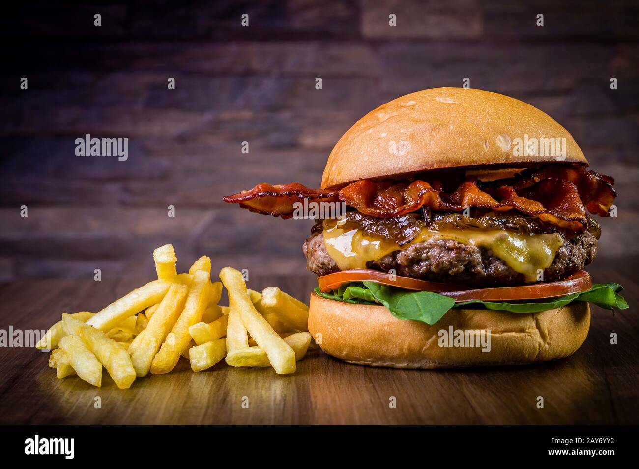 Craft beef burger with cheese, bacon, rocket leafs, caramelize onion ...