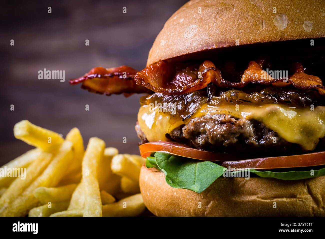 Craft beef burger with cheese, bacon, rocket leafs, caramelize onion ...