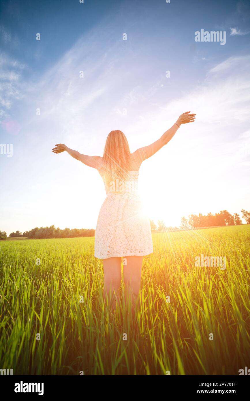 Happiness woman stay outdoor under sunlight of sunset Stock Photo - Alamy