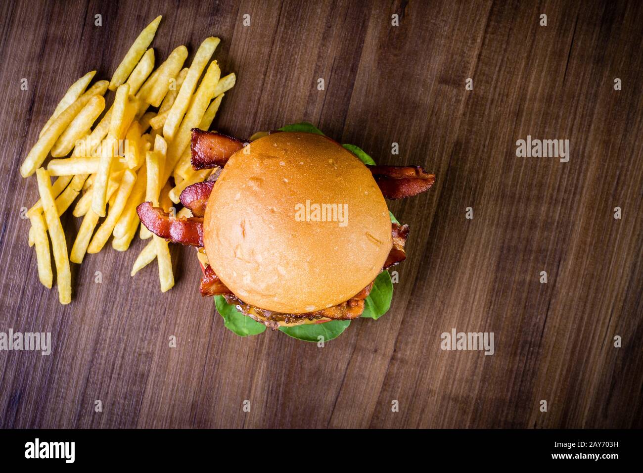 Craft beef burger with cheese, bacon, rocket leafs, caramelize onion ...