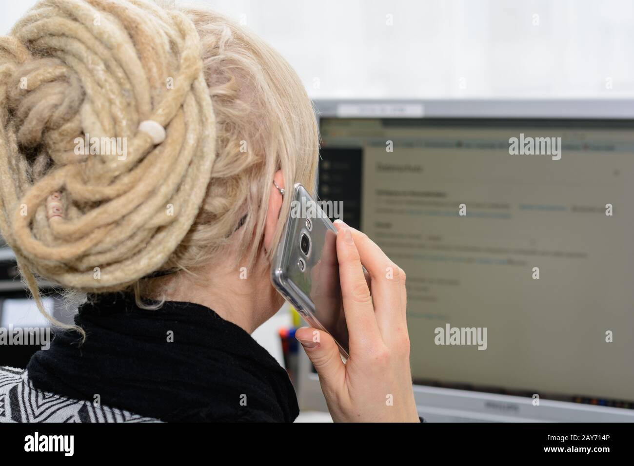 young secretary makes a phone call and works on the computer - close-up ...