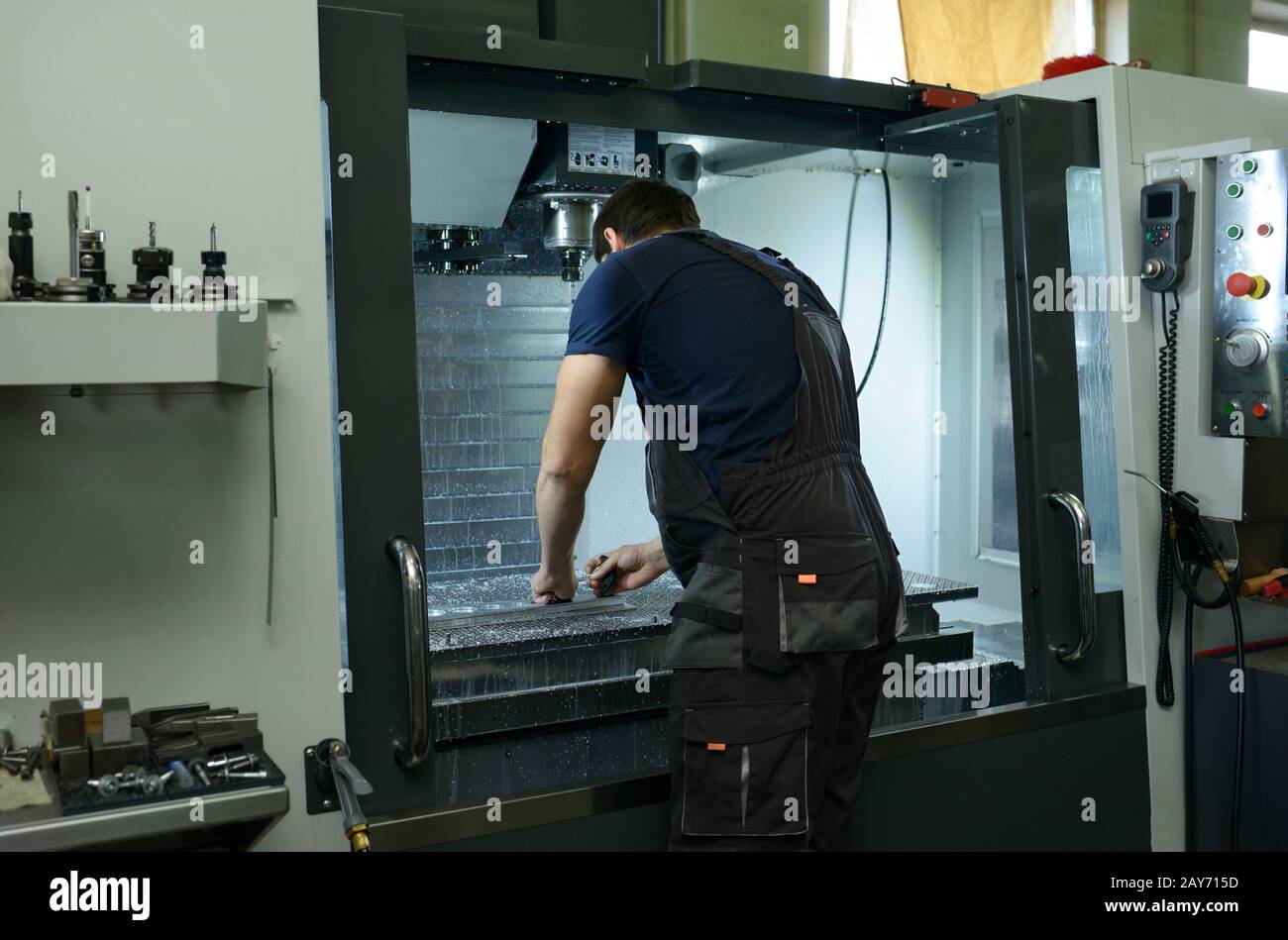 Worker fixing metal piece on the worktable of the milling machine Stock ...