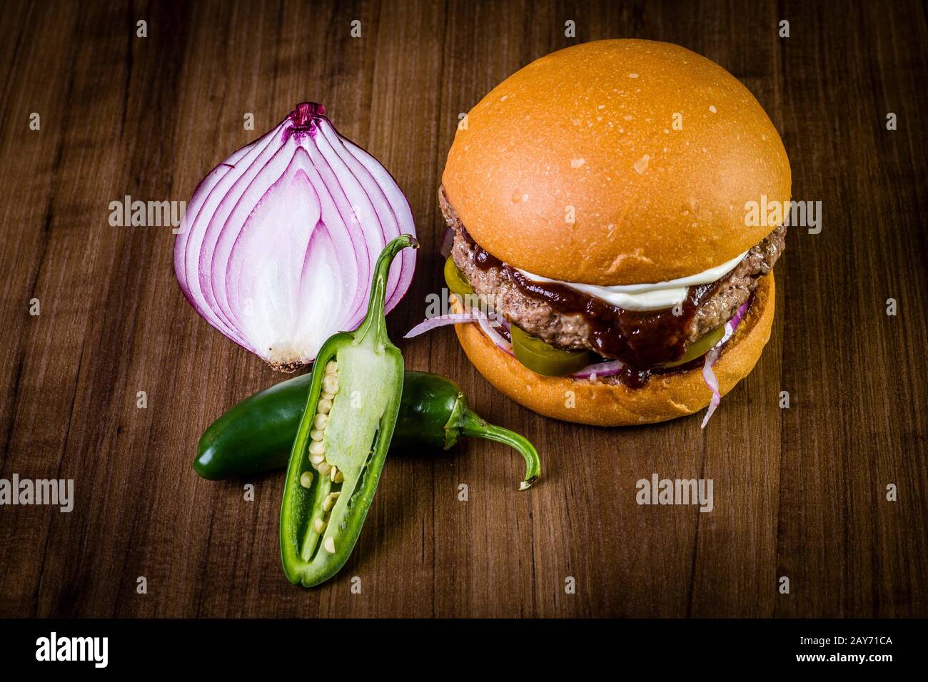 Craft beef burger with cream cheese, purple onion, jalapeno pepper on ...