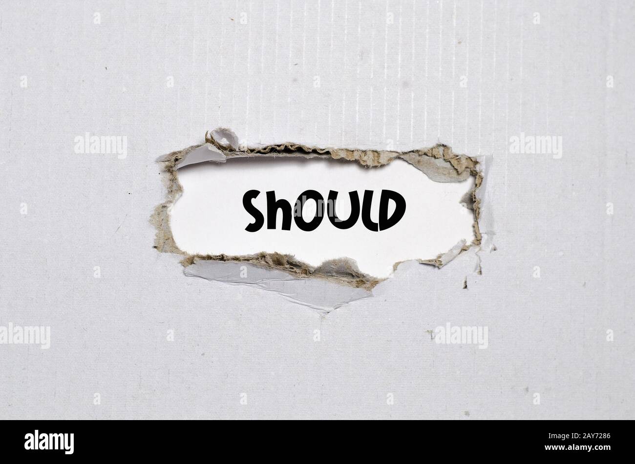 The word should appearing behind torn paper Stock Photo - Alamy