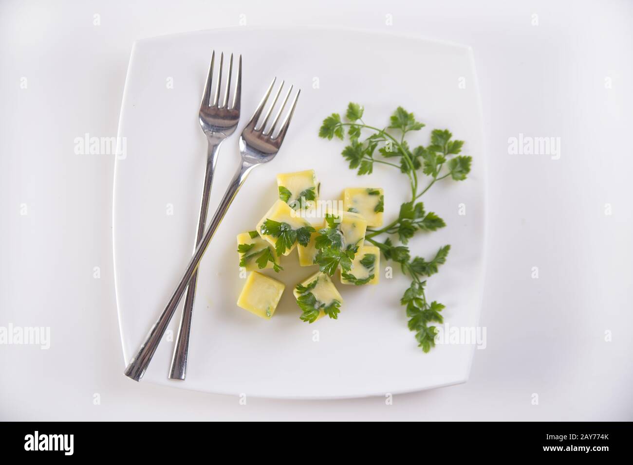 Oil cube frozen with parsley Stock Photo - Alamy