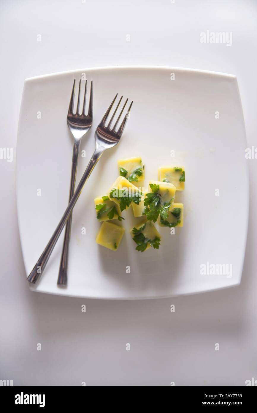Oil cube frozen with parsley Stock Photo - Alamy