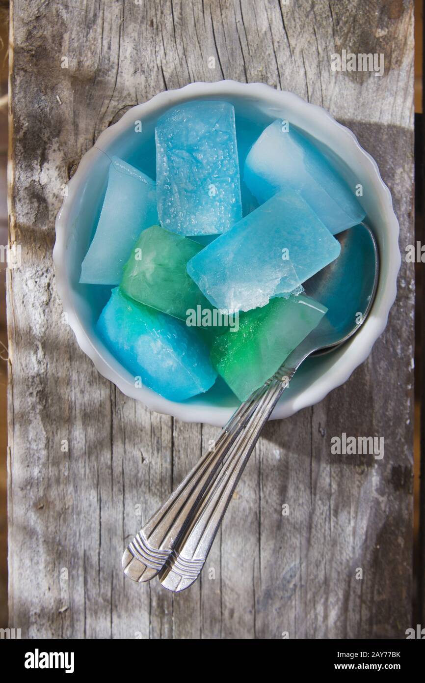 Bowl of colored ice-cubes Stock Photo - Alamy