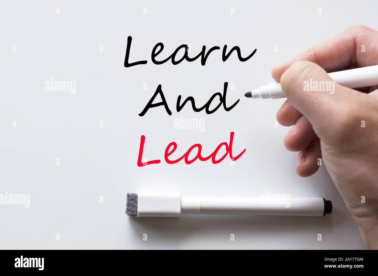Learn and lead written on whiteboard Stock Photo - Alamy