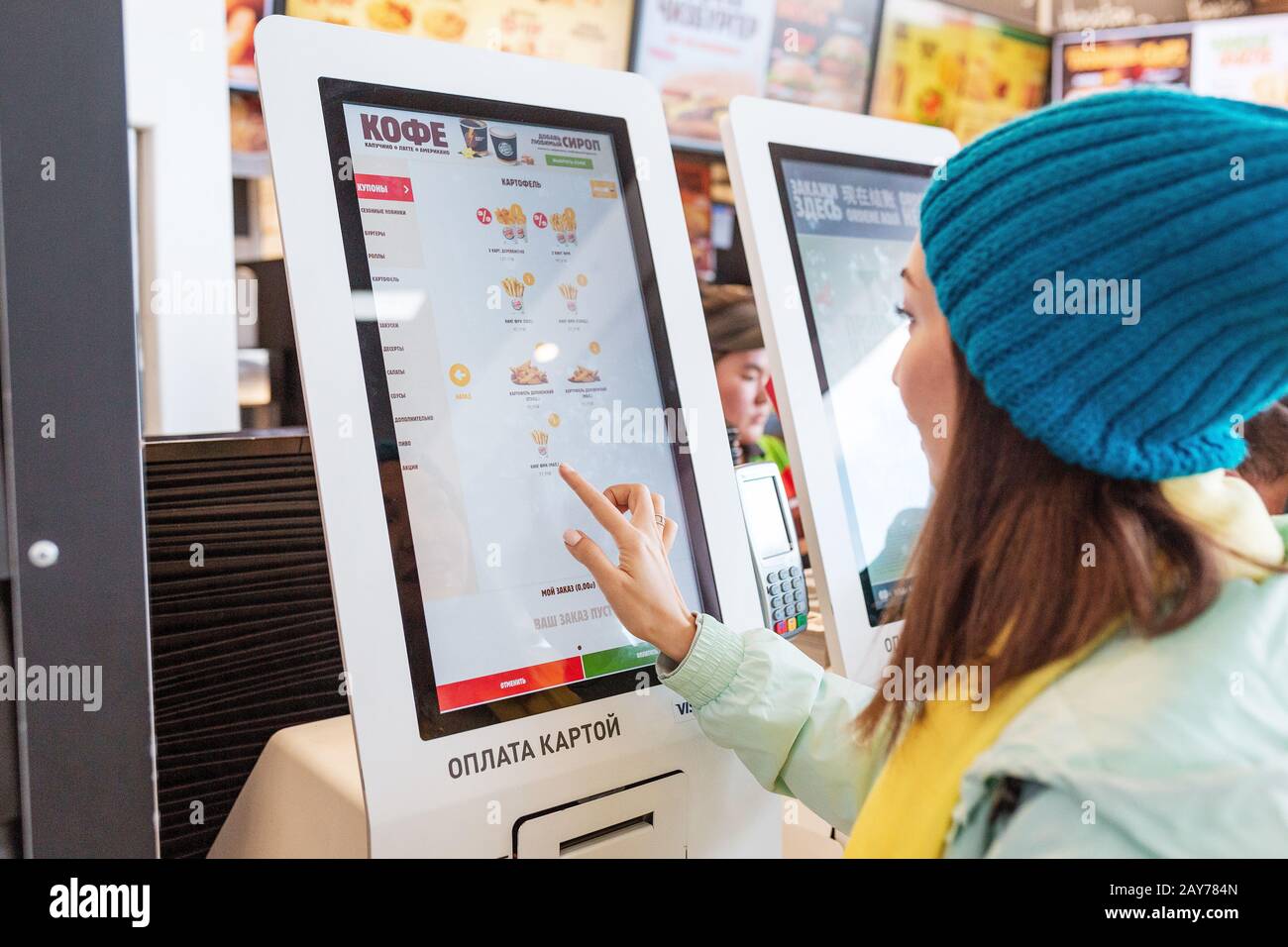 03 May 2019, Moscow, Russia: woman orders meal in the electronic touch ...