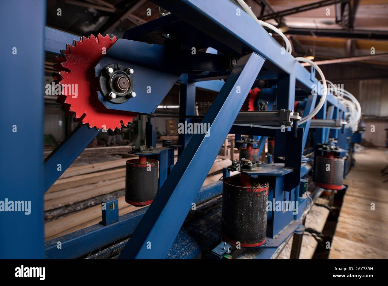 Processing of wooden logs with modern machinery Stock Photo - Alamy